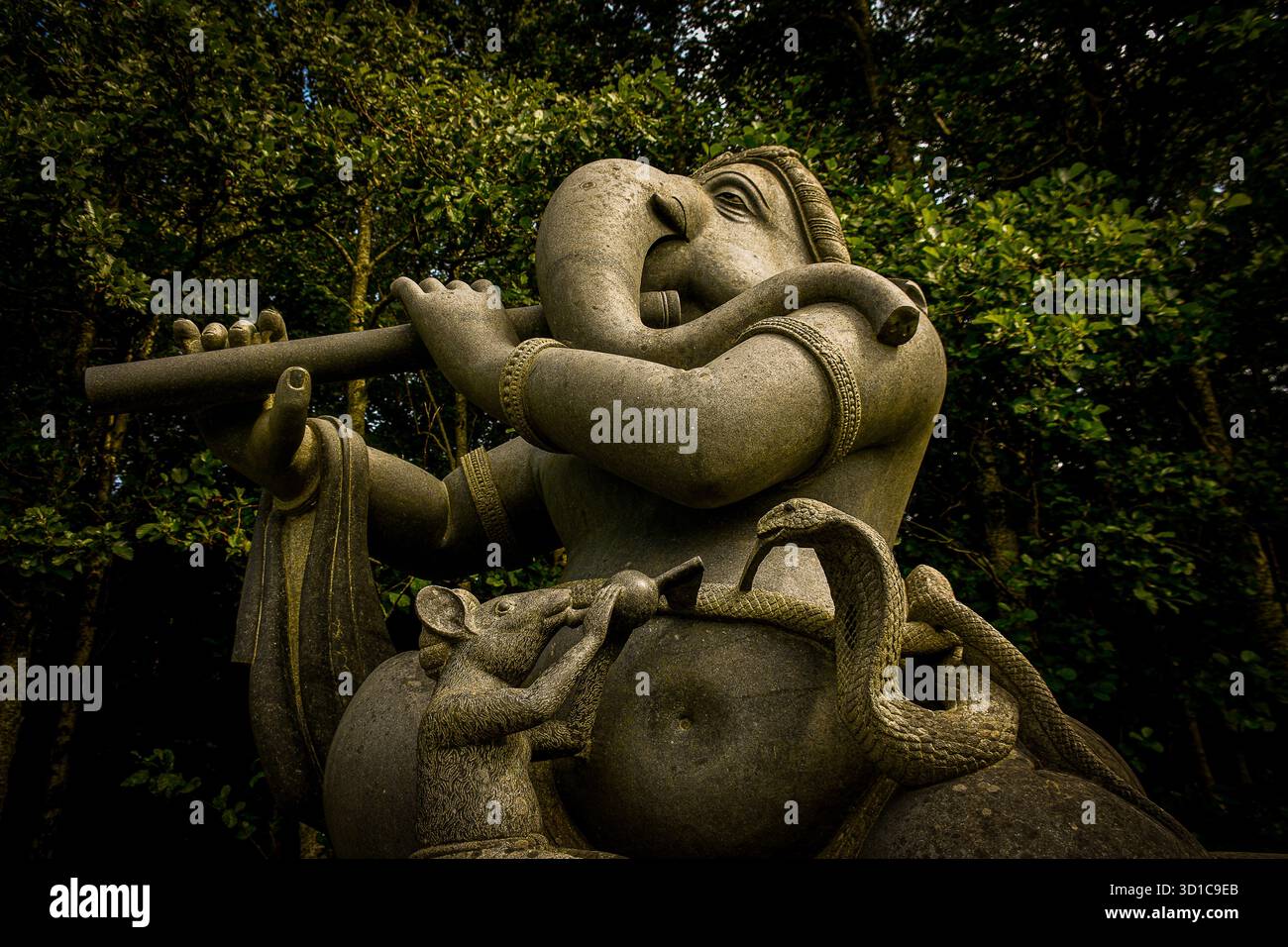 Stone statue of Ganesha playing a flute at Victor’s Way, County Wicklow ...