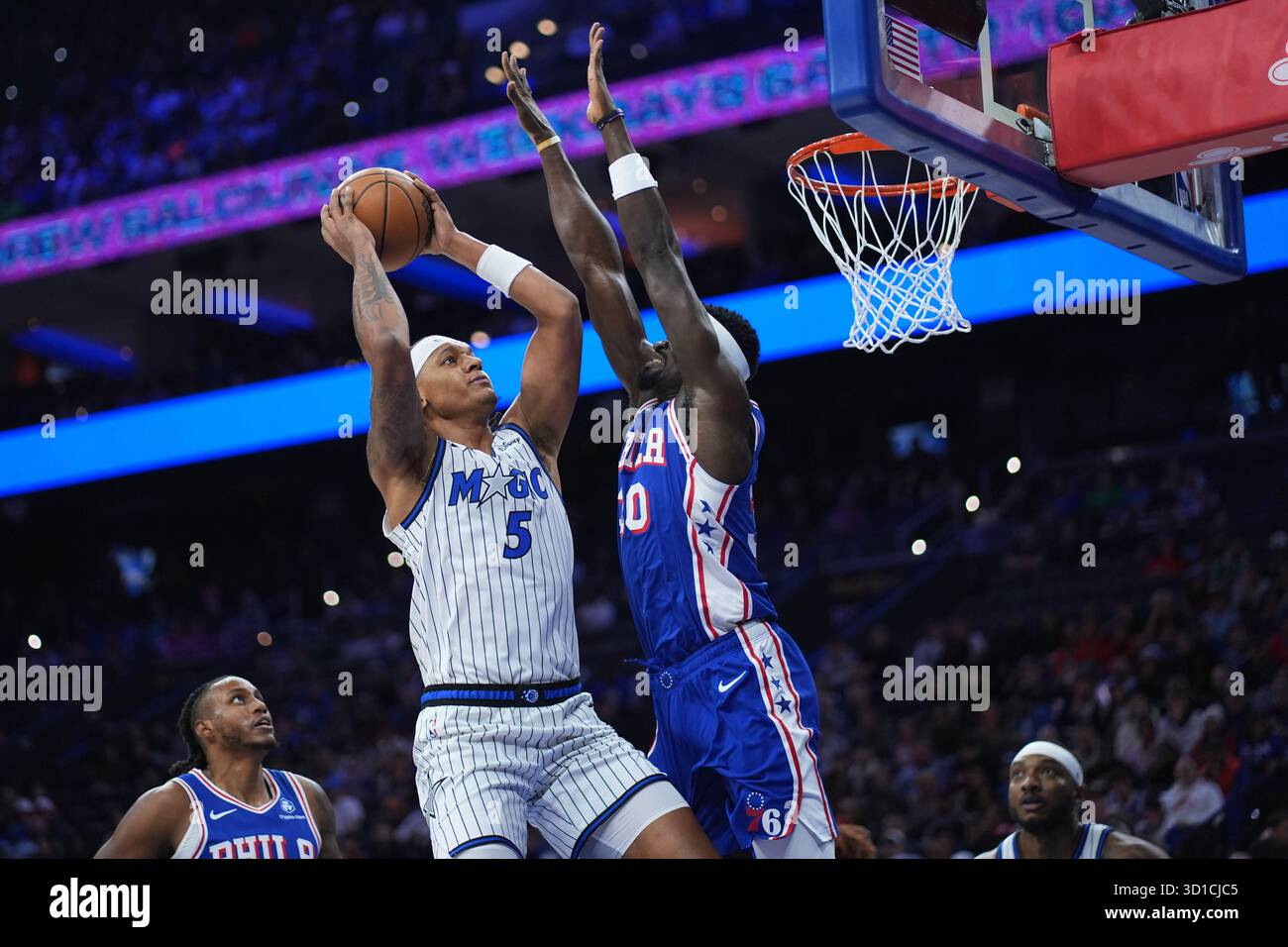 Orlando Magic's Paolo Banchero (5) goes up for a shot against Philadelphia 76ers' Adem Bona (30 ...