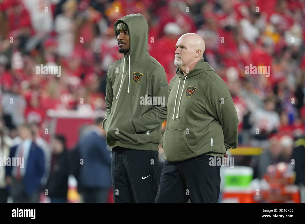 Washington Commanders head coach Dan Quinn, right, stands with ...