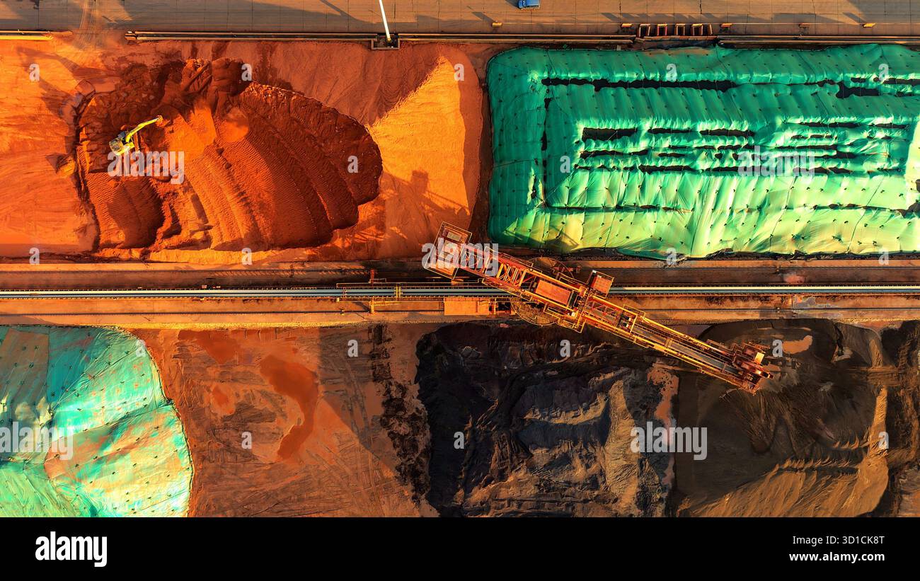 Mechanical equipment is sorting and loading imported iron ore at ...