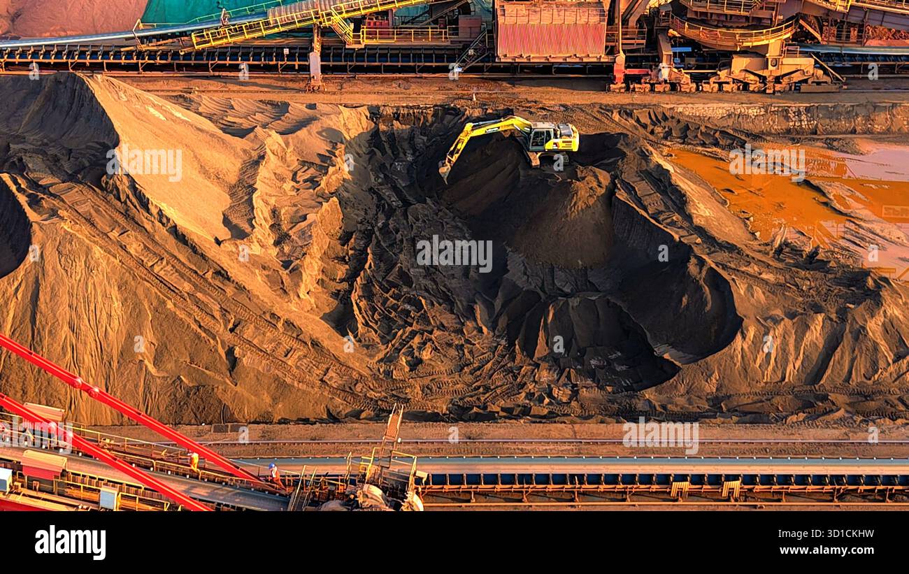 Mechanical equipment is sorting and loading imported iron ore at ...