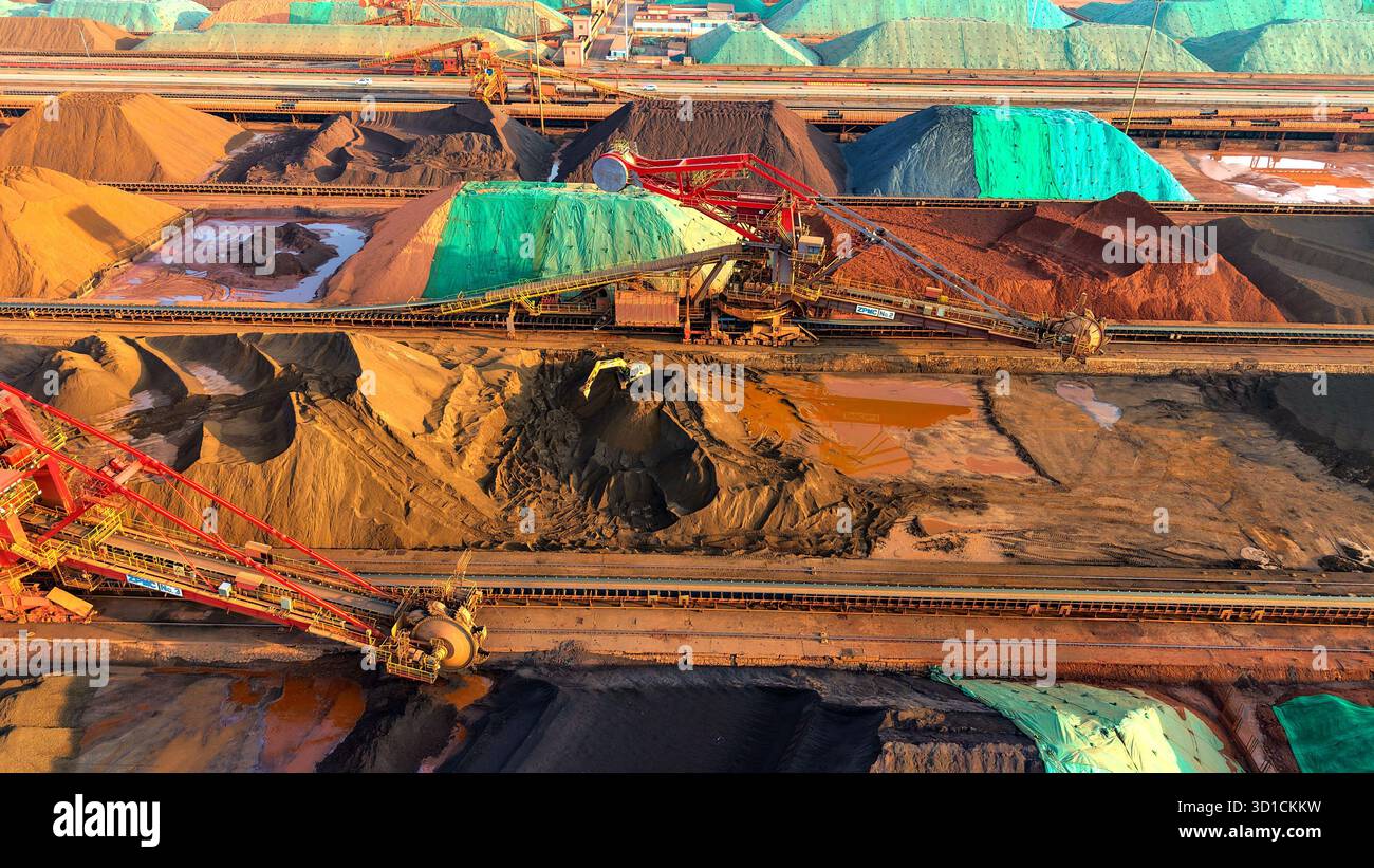 Mechanical equipment is sorting and loading imported iron ore at ...