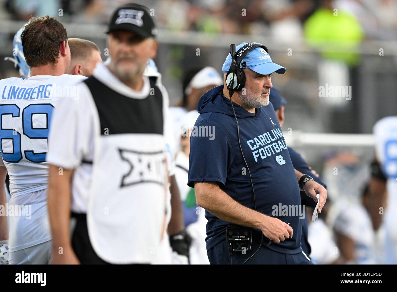 North Carolina offensive line coach Will Friend, right, looks on from ...