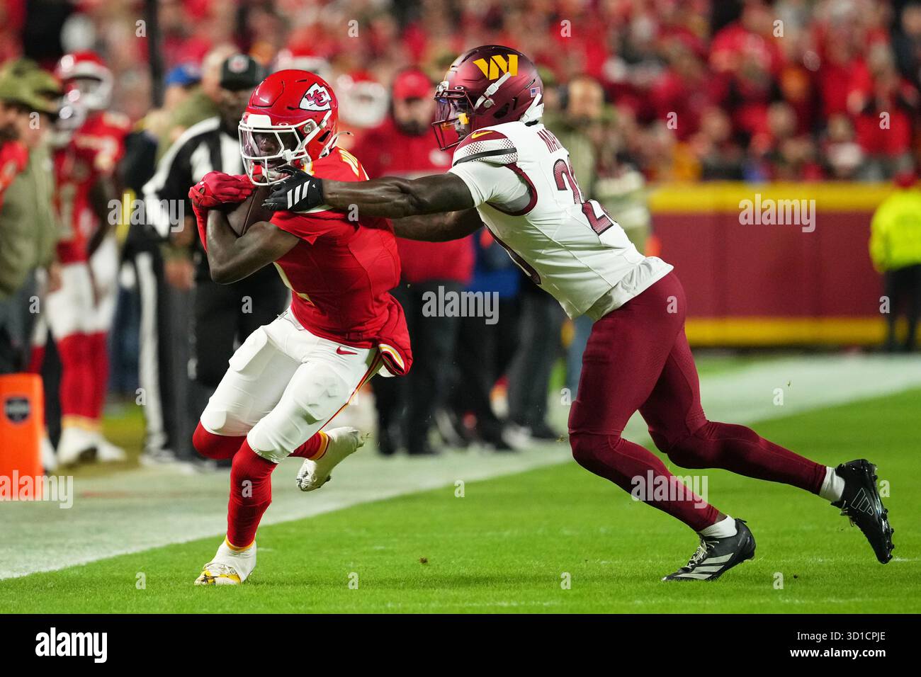 Kansas City Chiefs wide receiver Xavier Worthy, left, catches a pass as ...