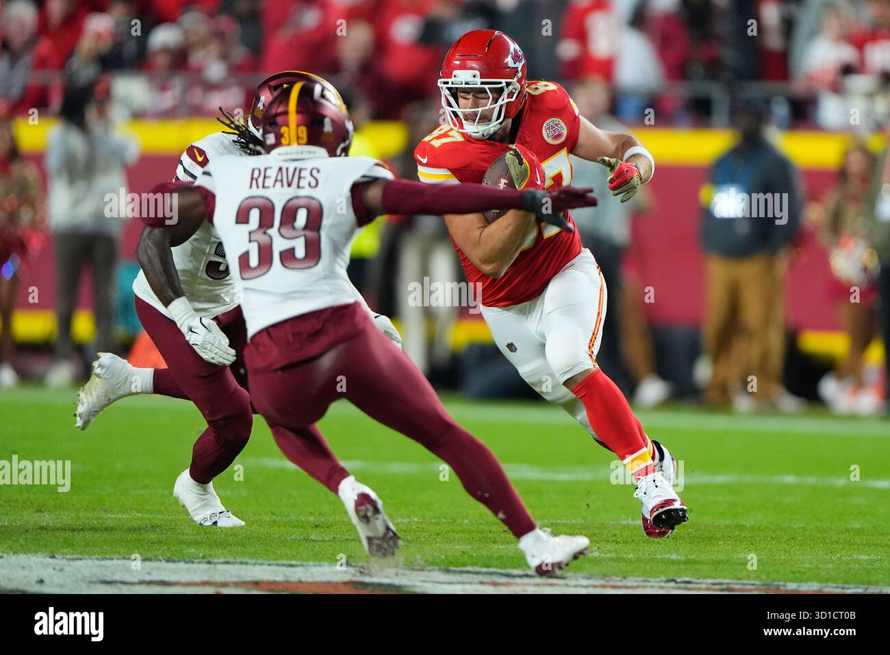 Kansas City Chiefs tight end Travis Kelce, right, runs with the ball as ...