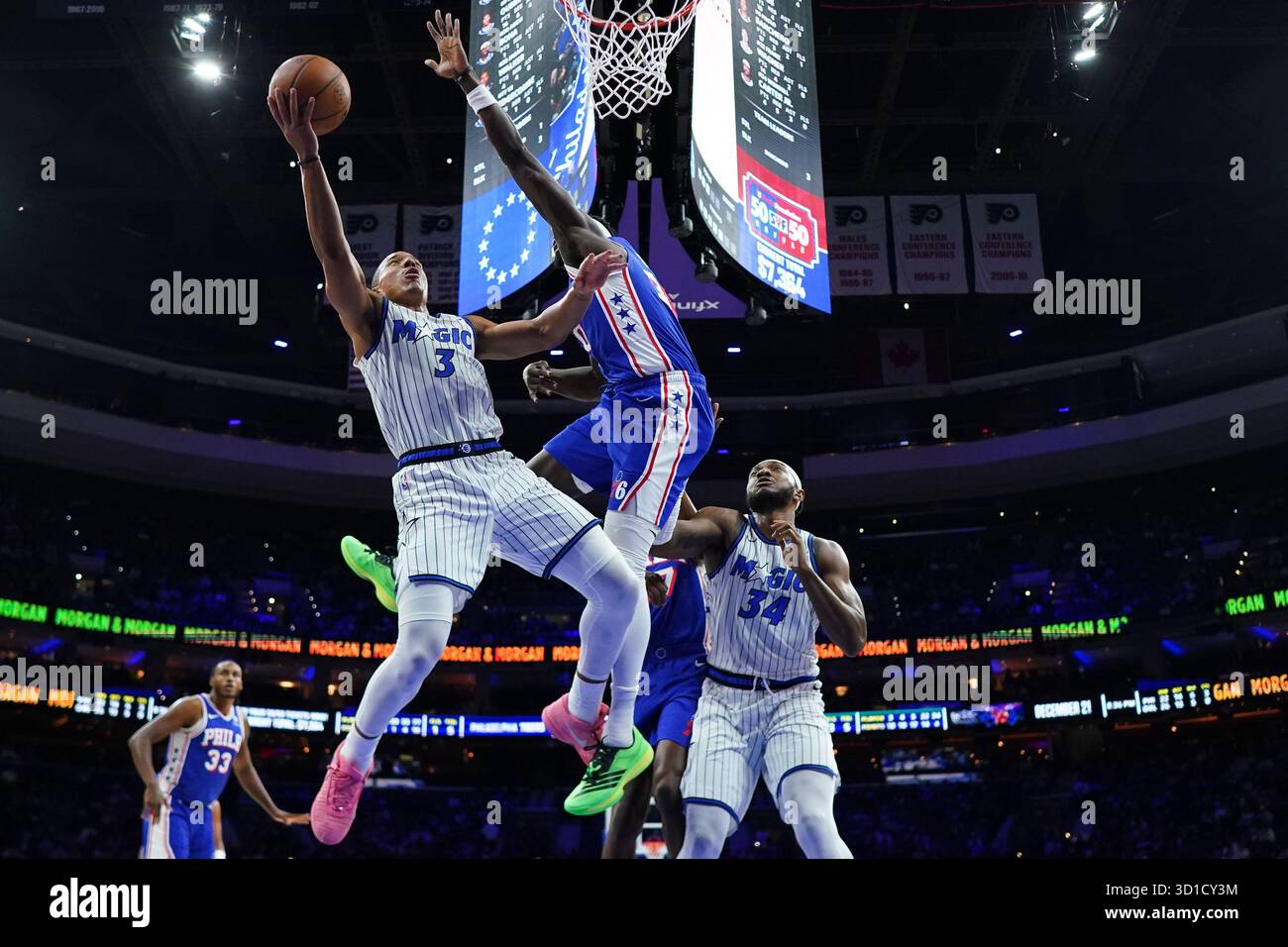 Orlando Magic's Desmond Bane, left, goes up for a shot against ...