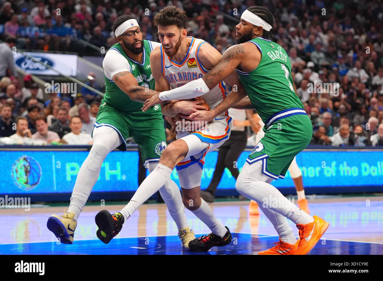 Oklahoma City Thunder center Chet Holmgren, center, tries to get past ...