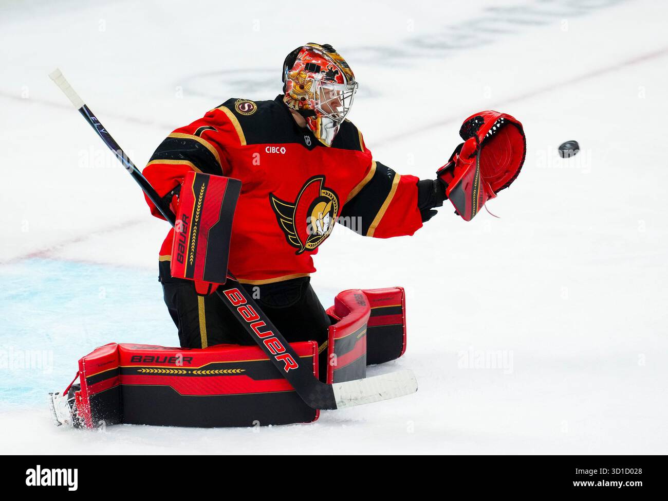 Ottawa Senators goaltender Leevi Merilainen makes a save while taking ...
