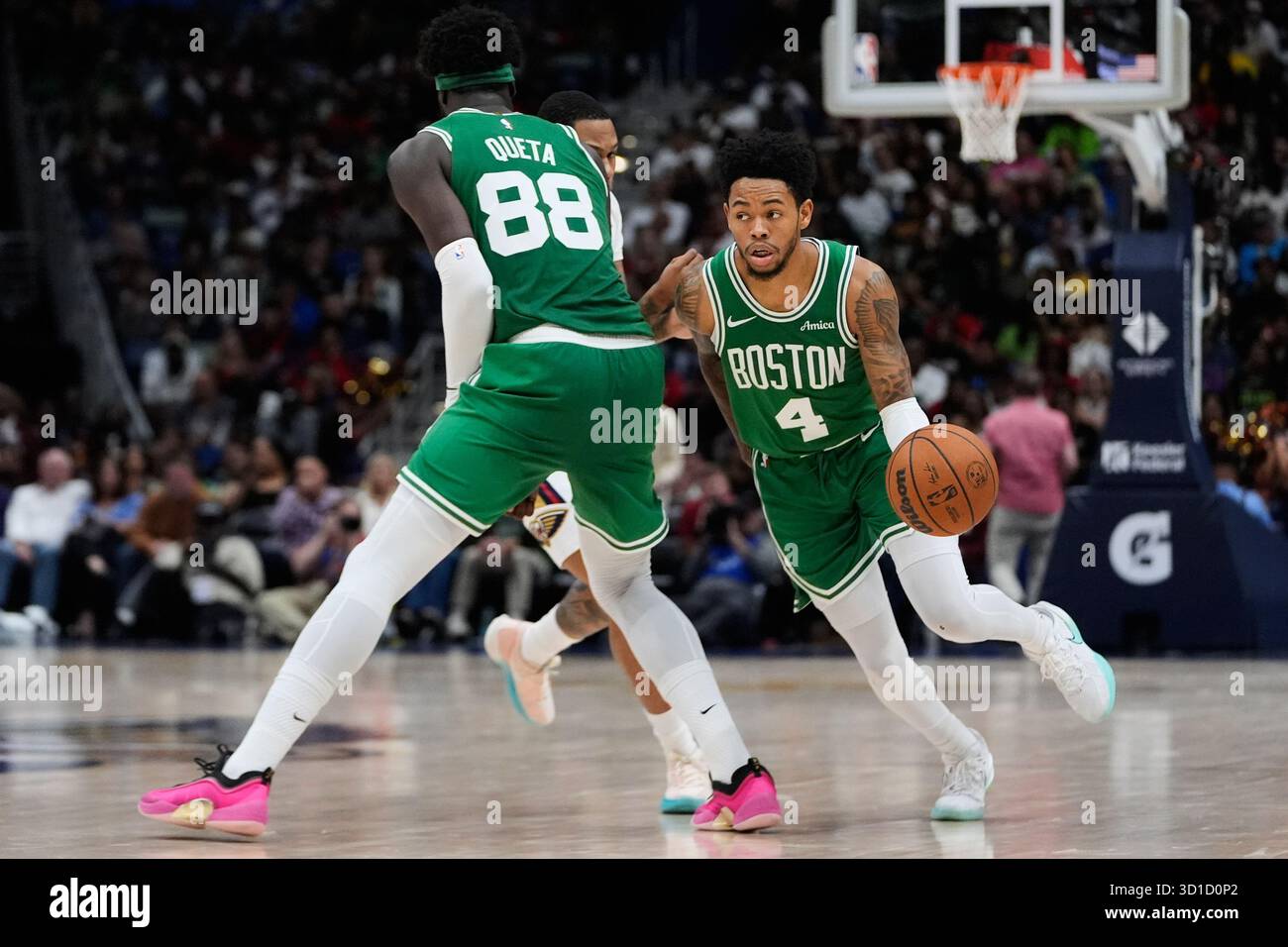 Boston Celtics guard Anfernee Simons (4) drives around center Neemias ...
