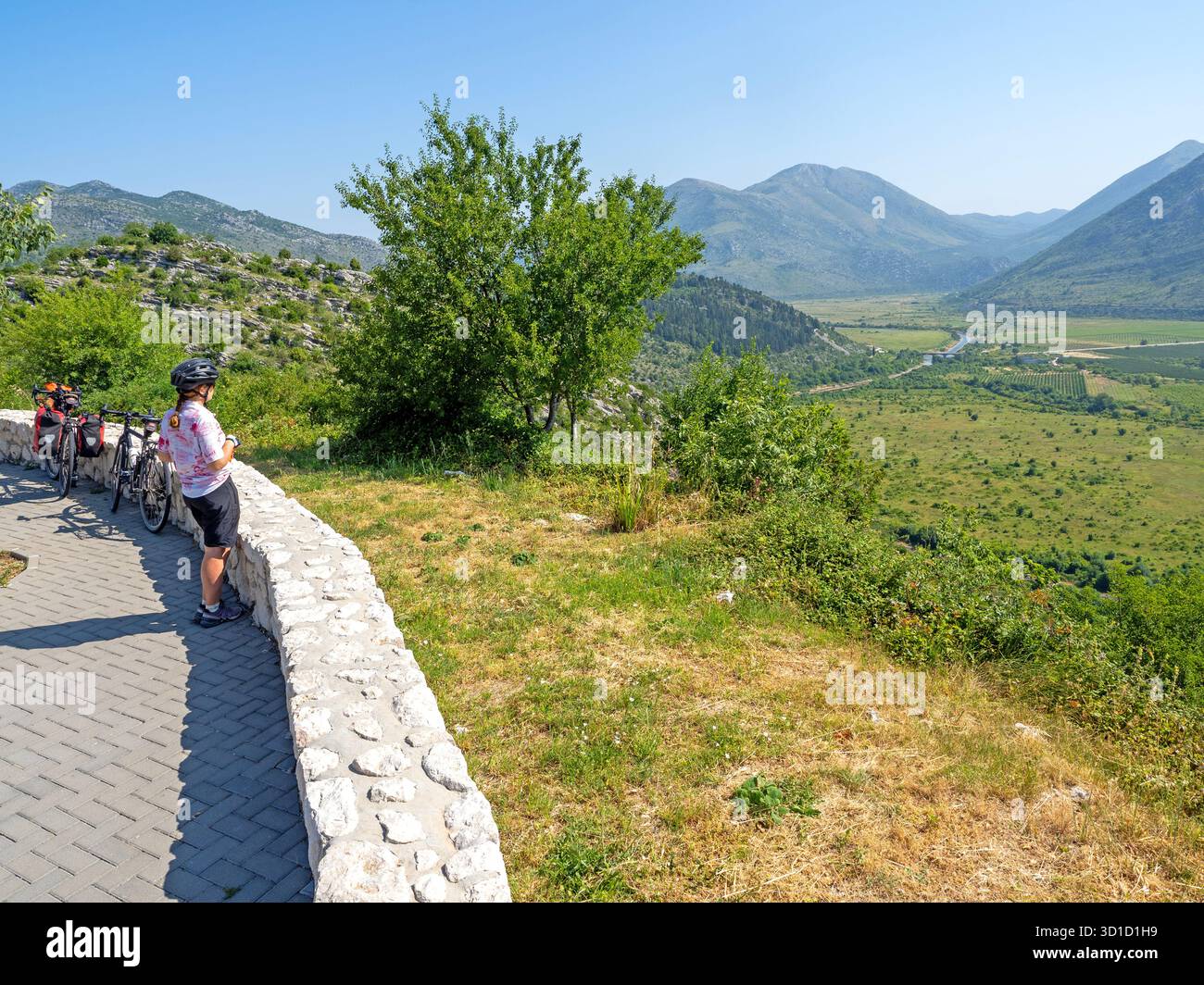 Cyclist on the Ciro Rail Trail overlooking Popovo Polje, one of the ...