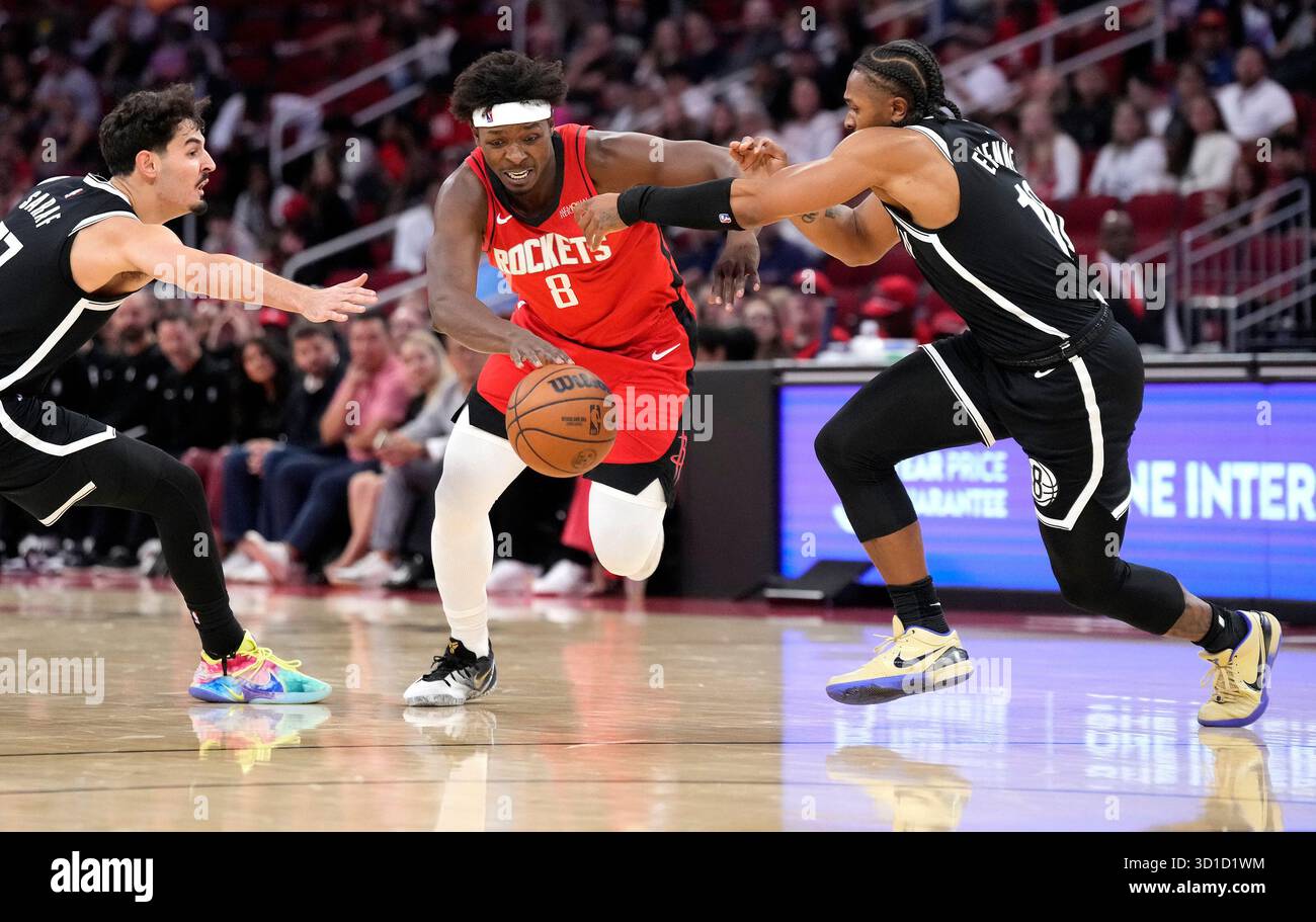 Houston Rockets forward Jae'Sean Tate (8) drives the ball between ...