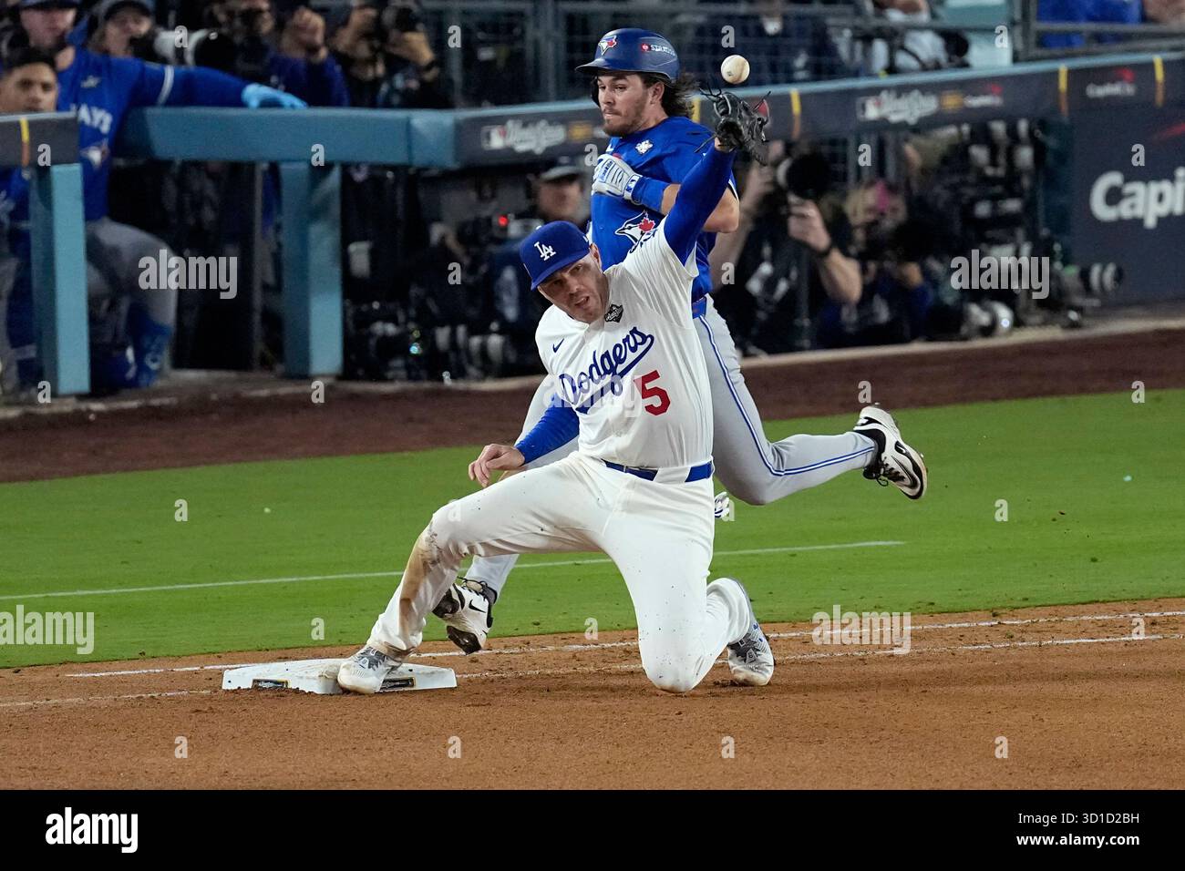Toronto Blue Jays' Addison Barger, right, reaches safely on a throwing ...