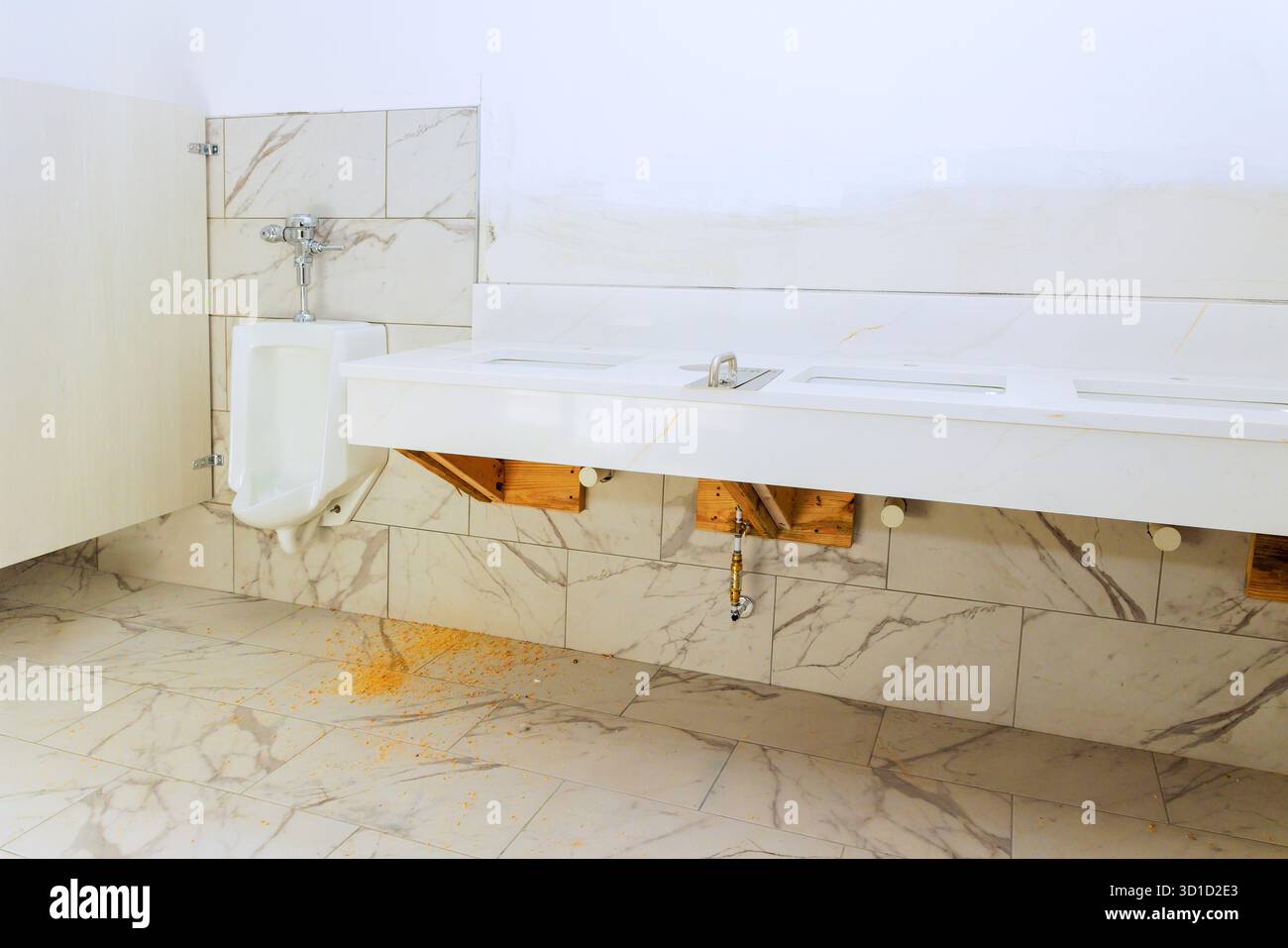 Restroom features new urinal exposed plumbing under sink, unfinished ...