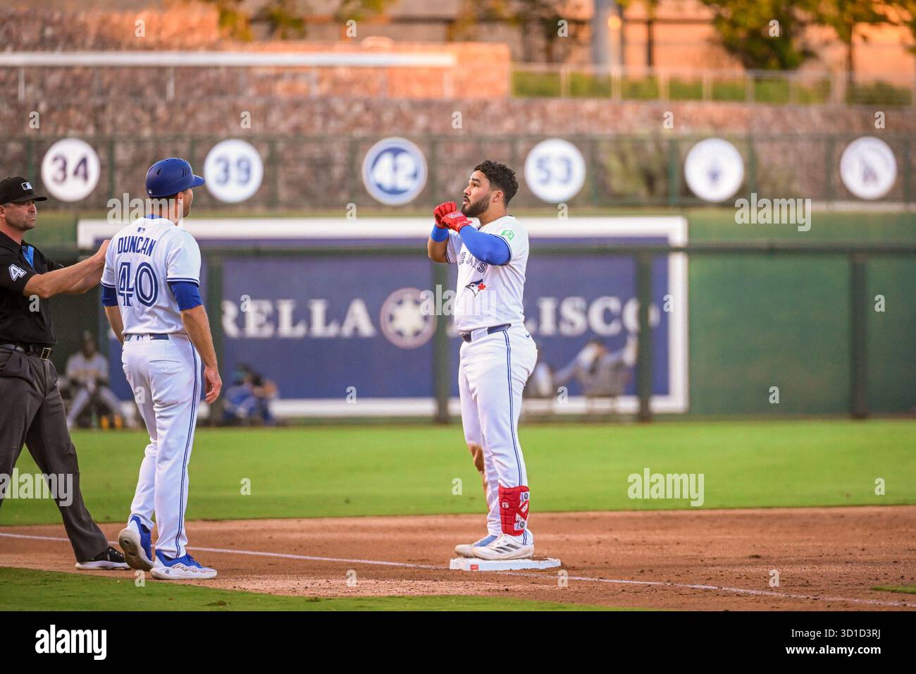 Glendale Desert Dogs catcher Edward Duran (17) triples in the second ...