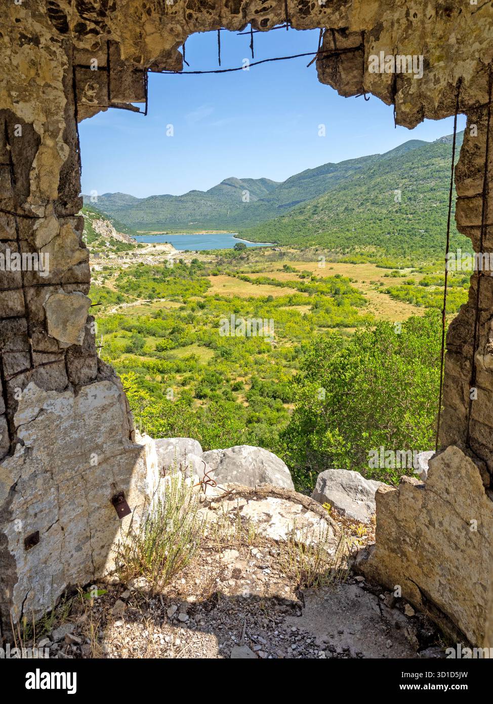 View through a ruined railway pillbox to Lake Vrutak along the Ciro ...