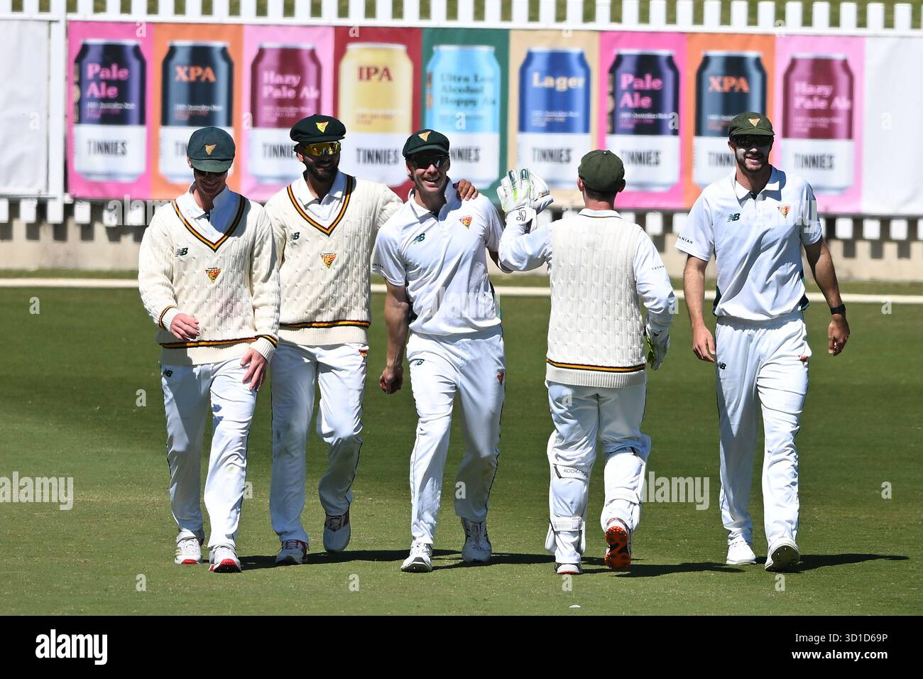 Riley Meredith of Tasmania (centre) celebrates with teammates after ...