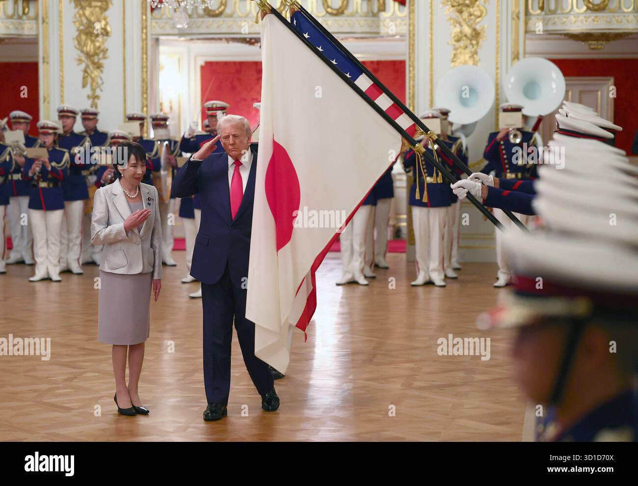 Japanese Prime Minister Sanae TAKAICHI (front left) and U.S. President Donald Trump (C) salute ...