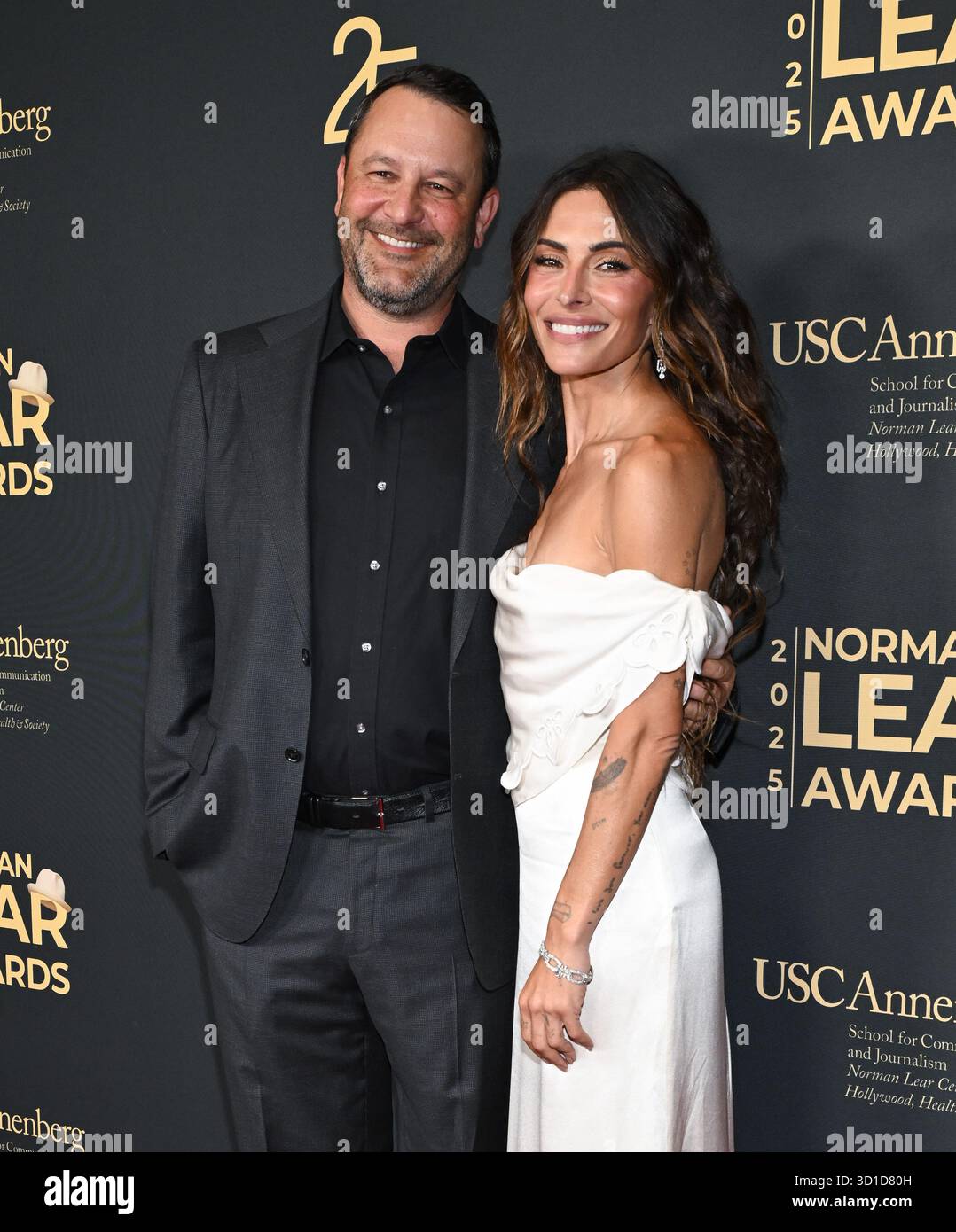 Dan Fogelman and Sarah Shahi arriving to The Norman Lear Awards 2025 at ...