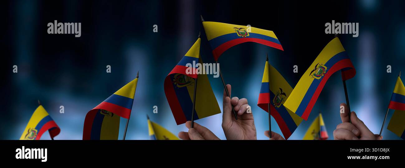 Ecuador flags in their hands on a blurred urban background. The photo ...
