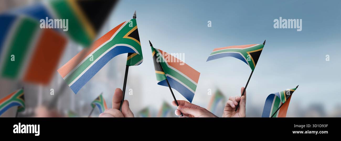 South Africa flags in their hands on a blurred urban background Stock ...