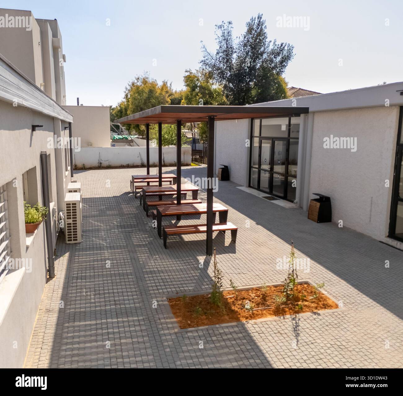 Aerial view of an outdoor seating area with wooden picnic tables under ...