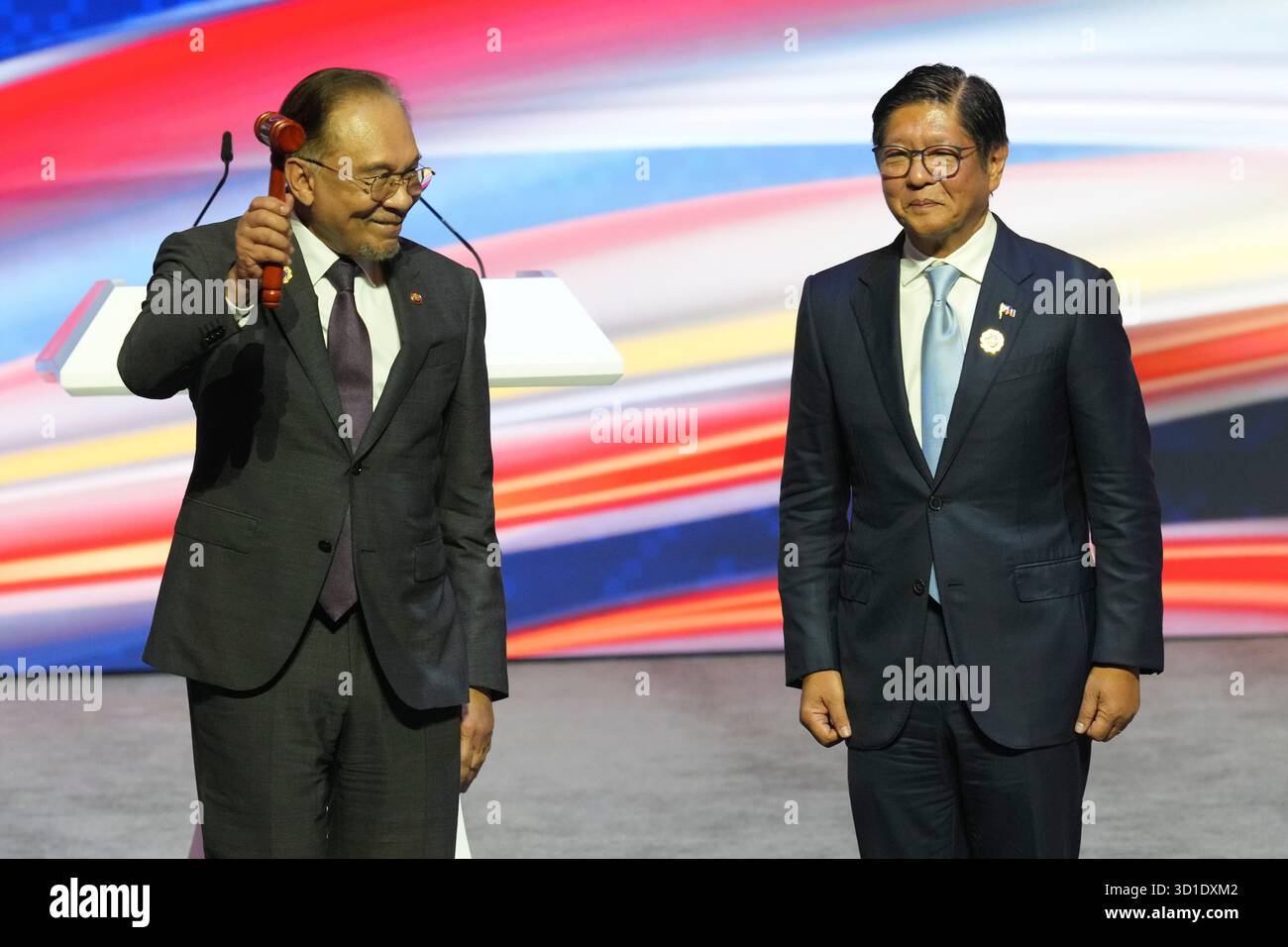 Malaysia's Prime Minister Anwar Ibrahim, left, holds a gavel before ...