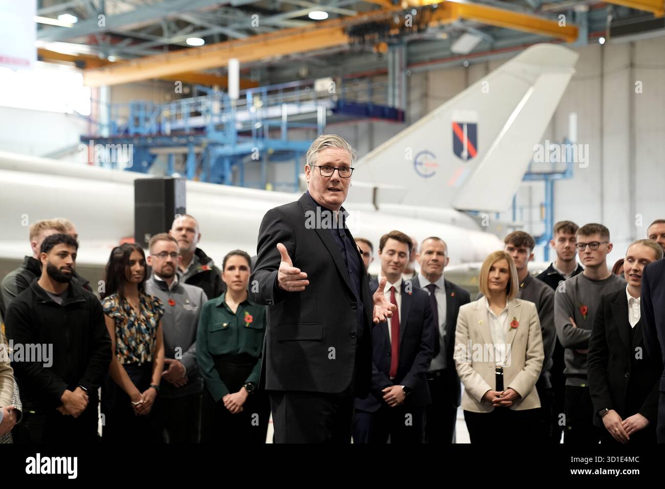 British Prime Minister Keir Starmer speaks to workers during a visit to ...