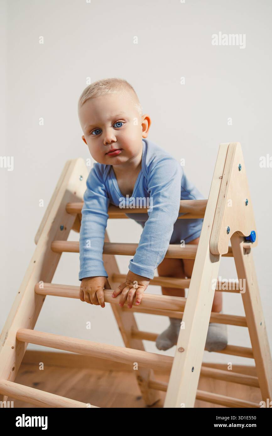 Joyful toddler explores wooden climbing hi-res stock photography and ...