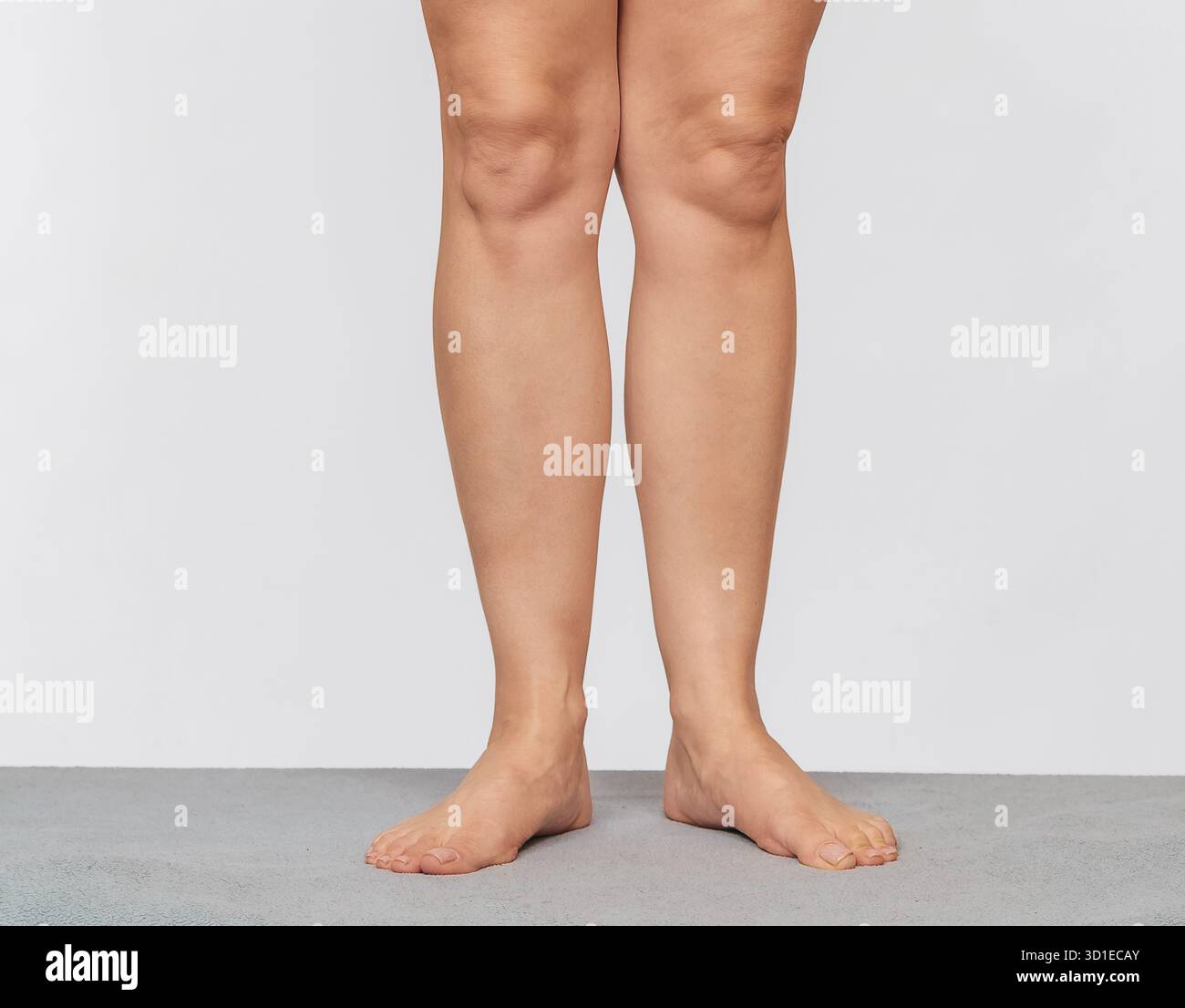 Long female legs standing on gray background. Care for clean and soft ...