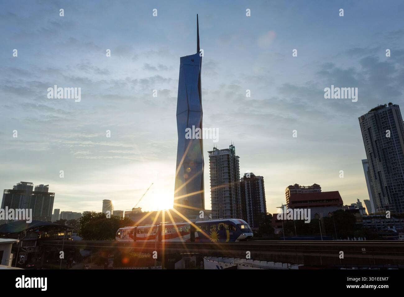 Merdeka 118 tower at sunset and the monorail running on foreground in ...