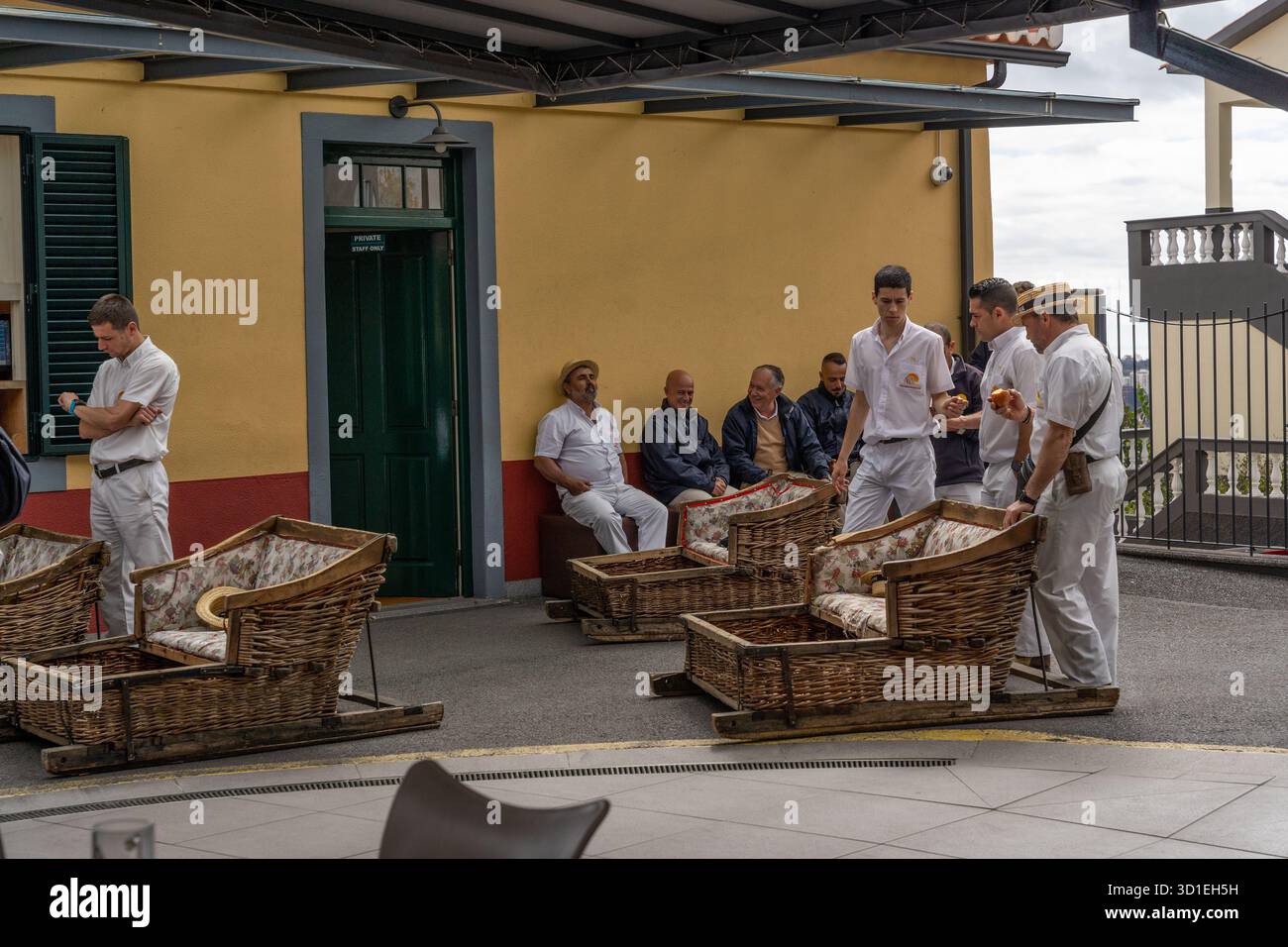 Funchal, Madeira, Portugal - 03.27.2025: Carreiros with wicker baskets ...