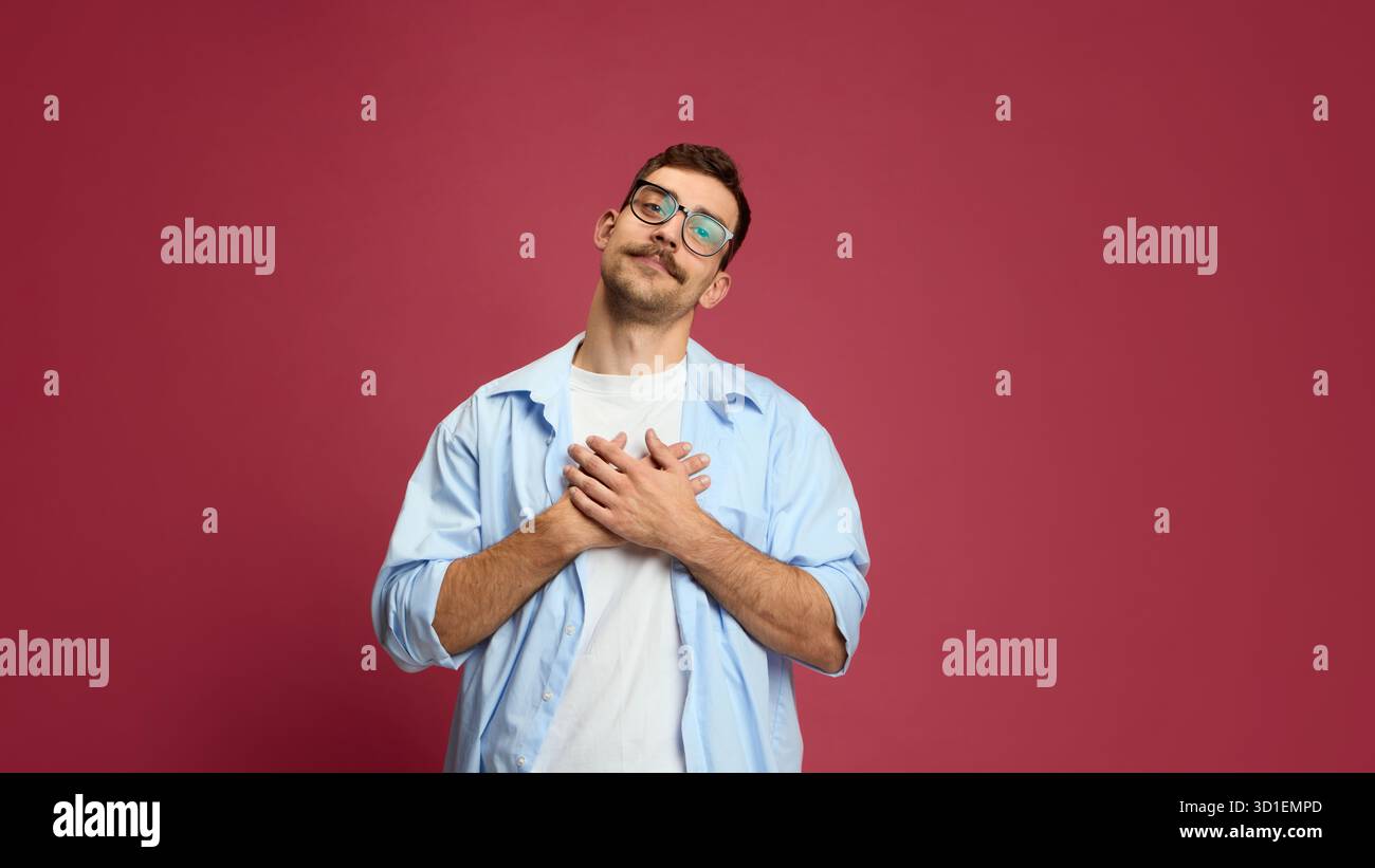 Grateful man holding hands on chest showing kindness and emotional ...