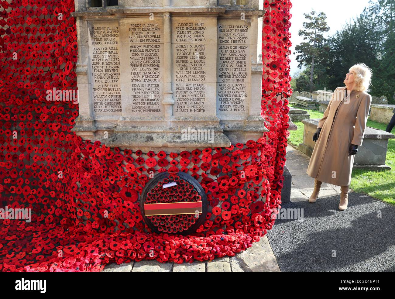 Queen Camilla after attaching the final poppy to complete the cascade ...