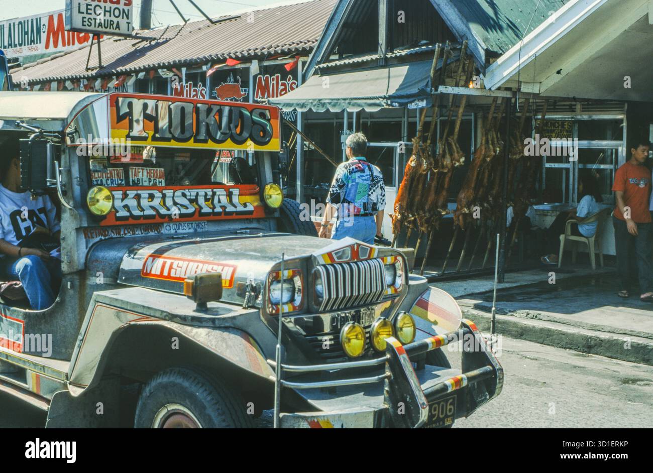 Jeepney Minibus vor einem Restaurant mit aufgespießten Spanferkel ...