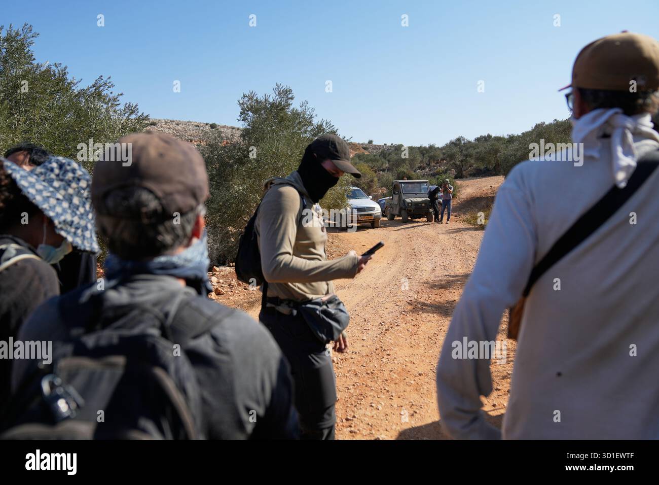 Israeli settlers block the main road that goes through Palestinian ...