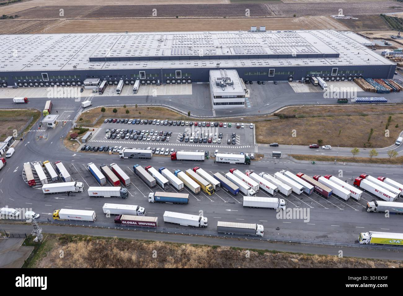 Large logistics warehouse with numerous trucks and vehicles parked ...