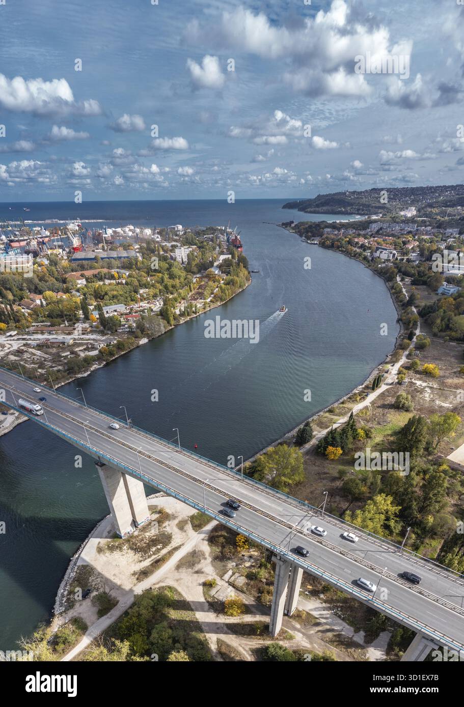 Aerial view of a bridge with cars spanning a winding river within an ...