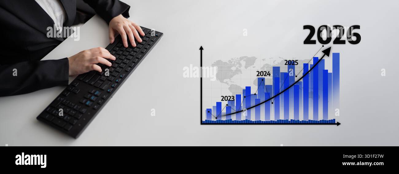 A business professional types on a keyboard while analyzing a projected ...