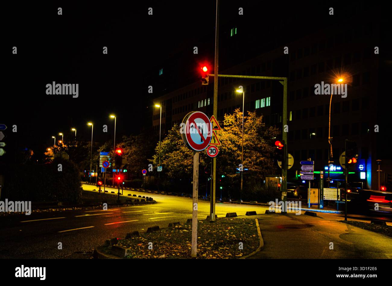 Urban Intersection at Night with Traffic Lights and Street Signs Stock ...