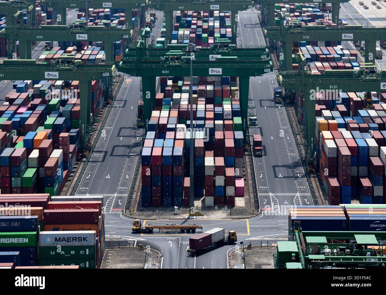 Container trucks drive through the port in Singapore on Tuesday Oct. 28 ...