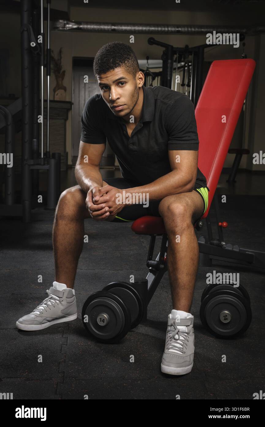 Handsome young african descent Mixed-race man sitting and resting on ...