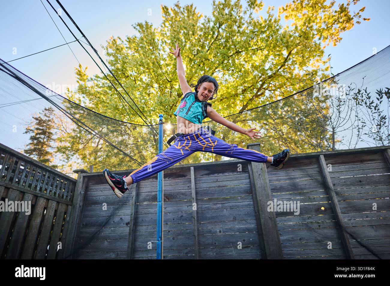 Eight-year-old Betsy Schruder jumps on her backyard trampoline in her ...