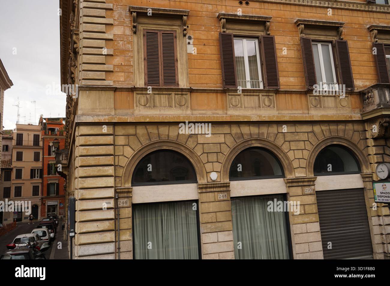 Classic Roman building facade with warm ochre and terracotta colors ...