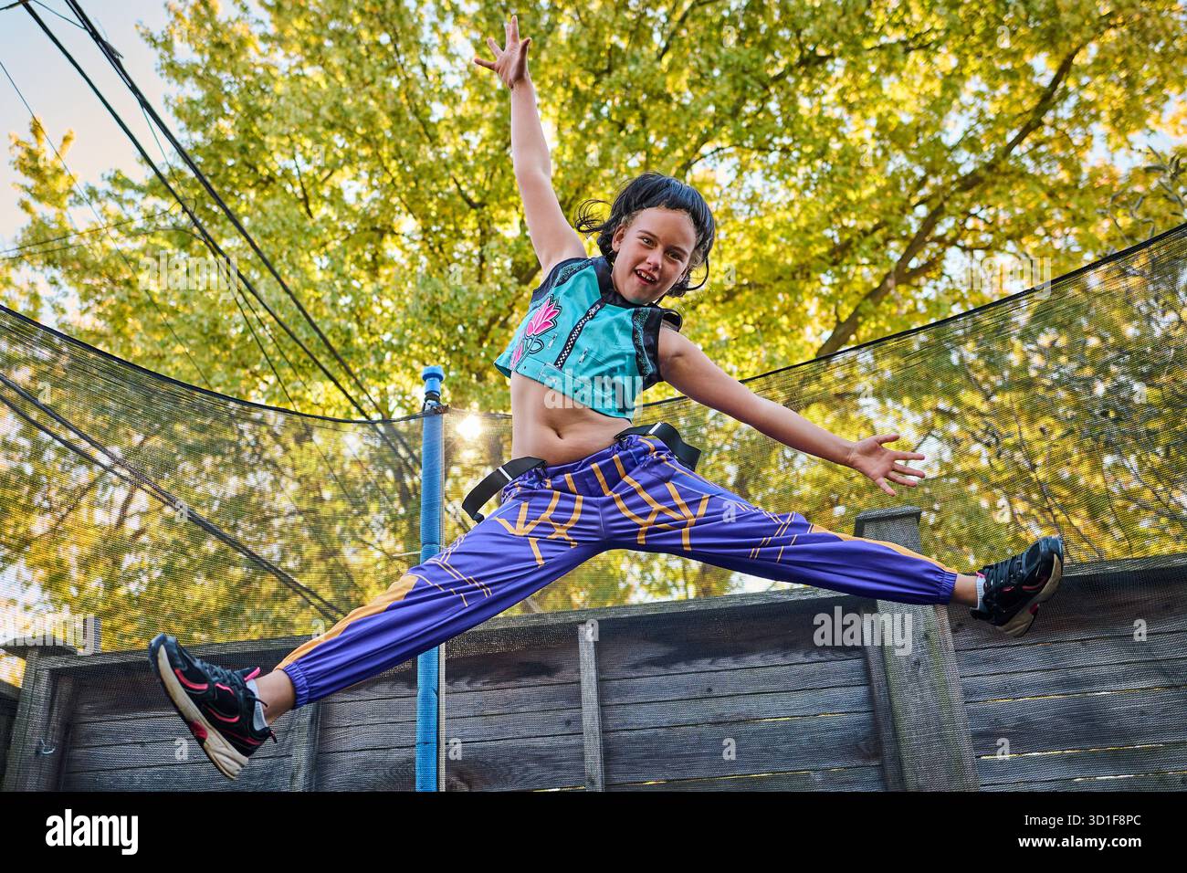 Eight-year-old Betsy Schruder jumps on her backyard trampoline in her ...