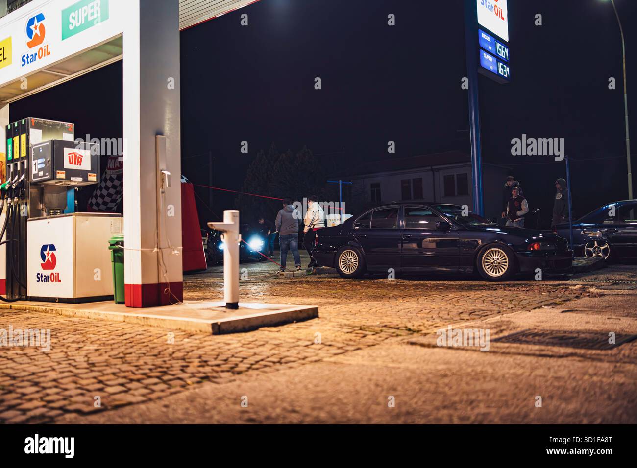 Este, italy 28 october 2025: staroil gas station at night with friends ...