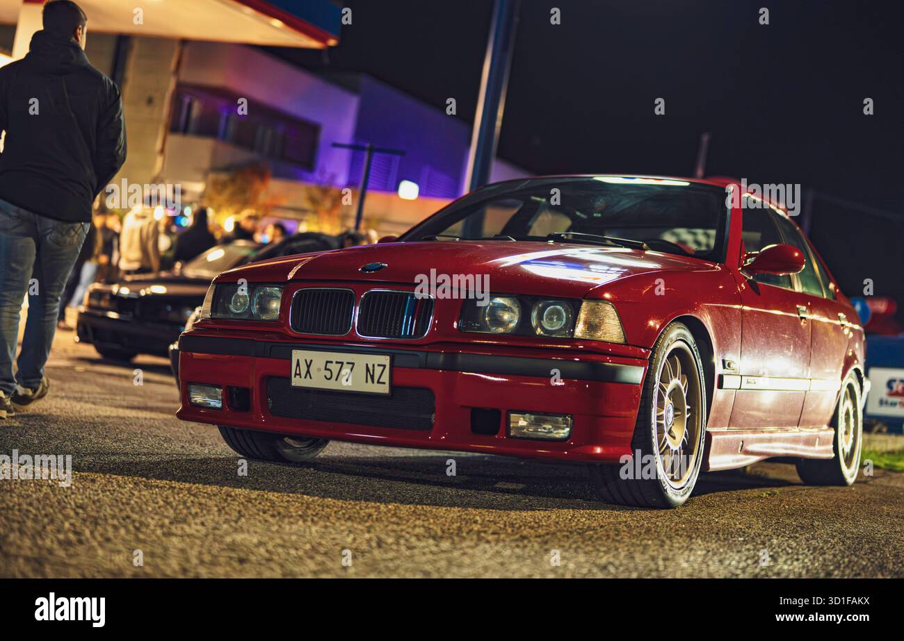 Este, italy 28 october 2025: custom red bmw e36 sedan parked at ...