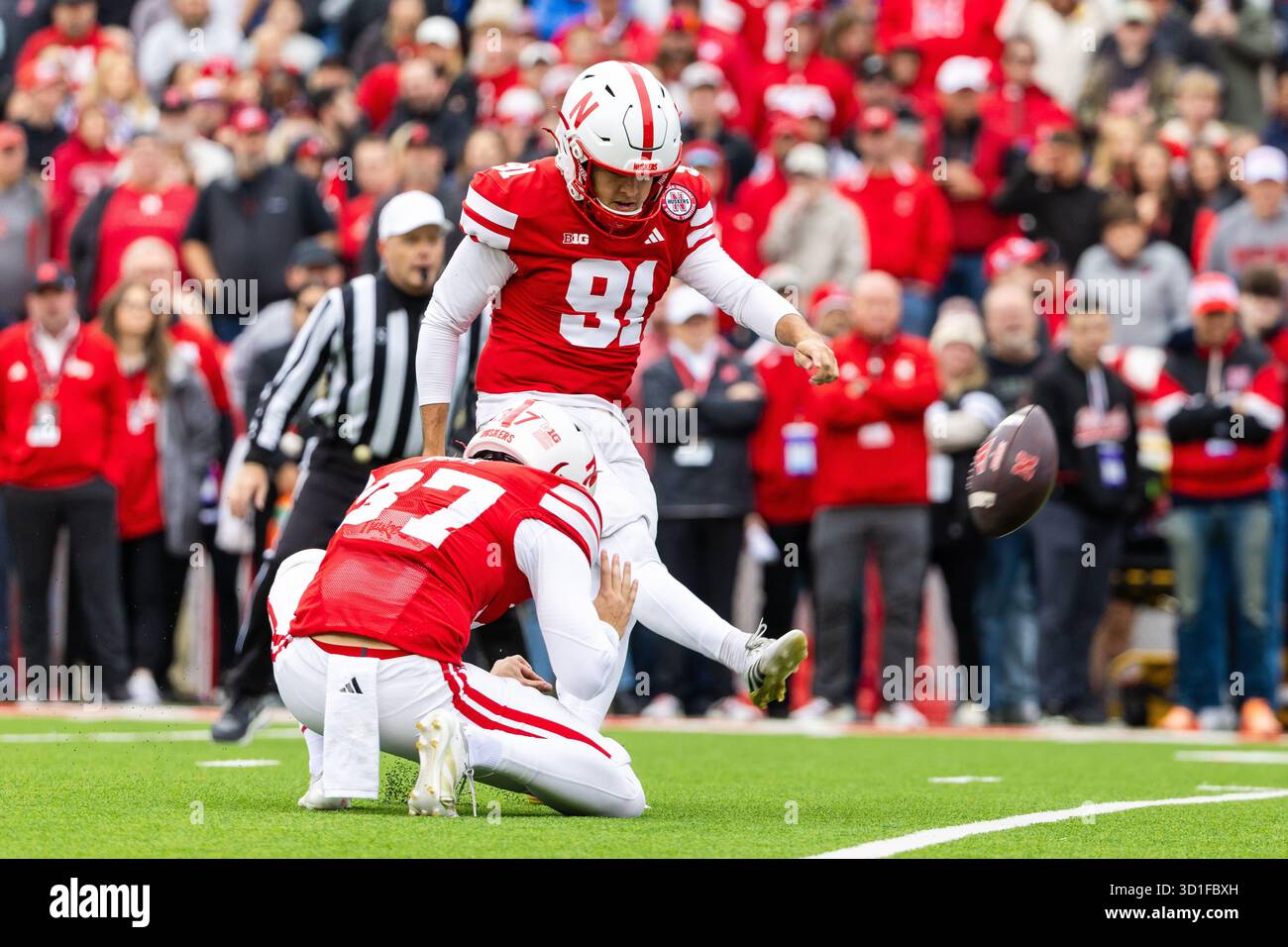 Nebraska kicker Kyle Cunanan (91) kicks a point after touchdown against ...