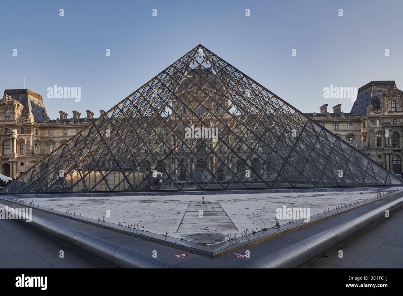 View of the famous Louvre museum and glass Pyramid at sunrise. The most ...