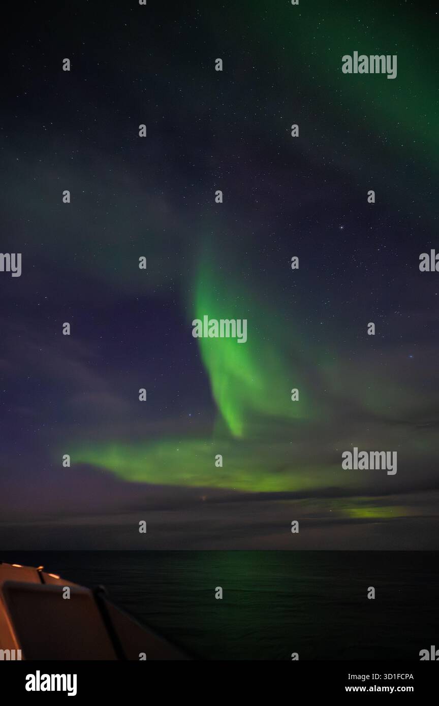 A stunning view of the Northern Lights illuminates the night sky over ...