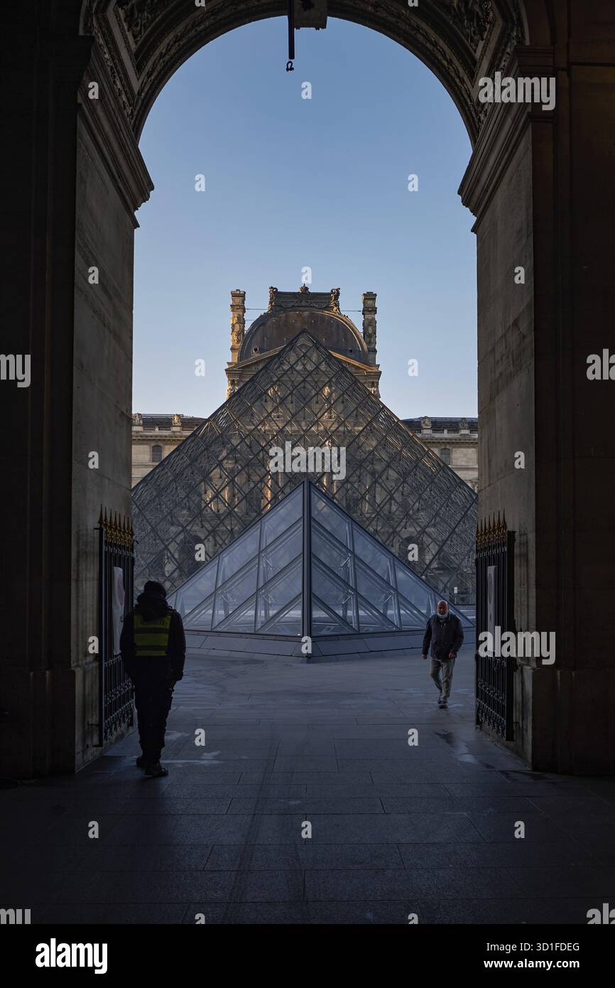 View of the famous Louvre museum and glass Pyramid at sunrise. The most ...